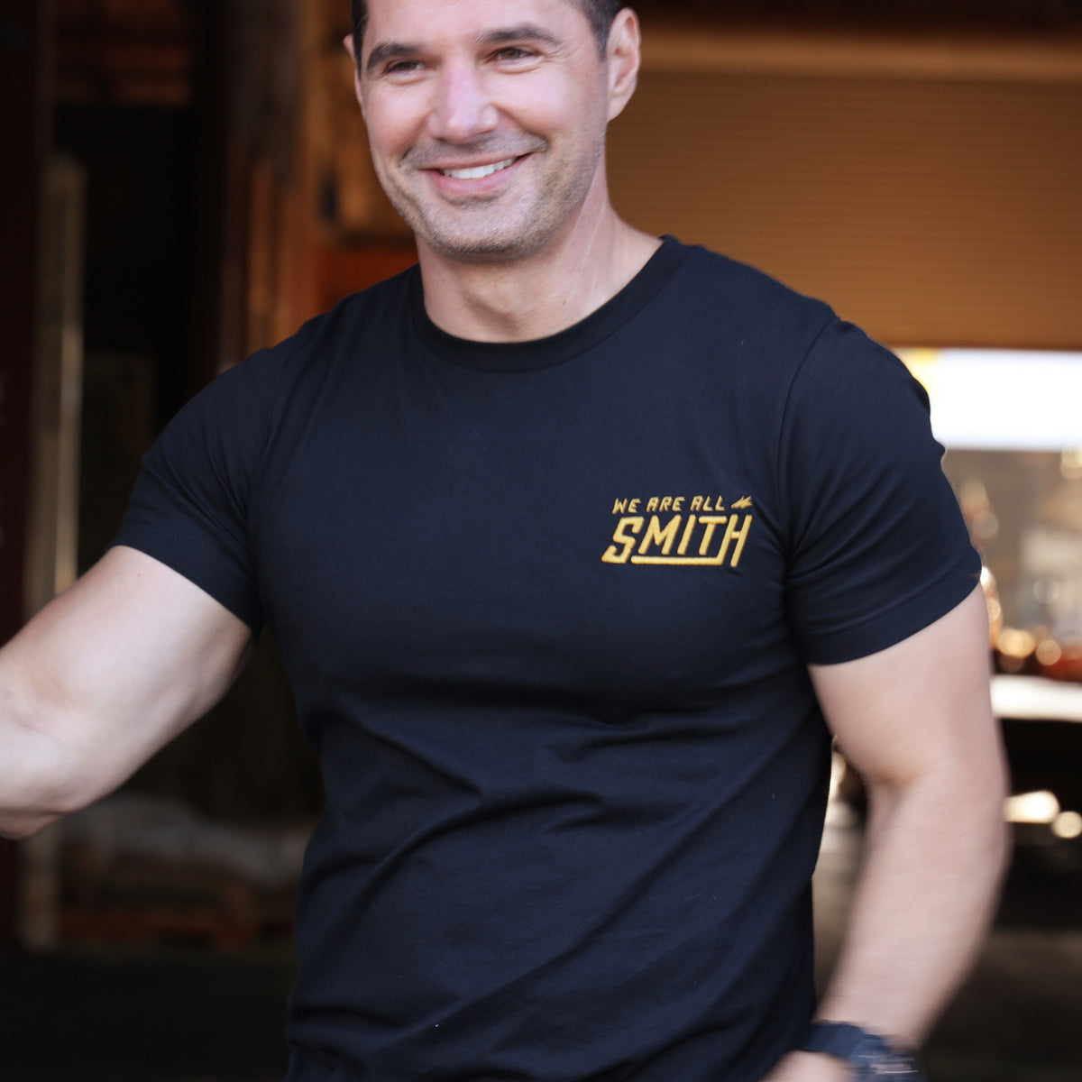 Gold We Are All Smith Embroidered Logo Black Unisex t-shirt — WE ARE ALL SMITH